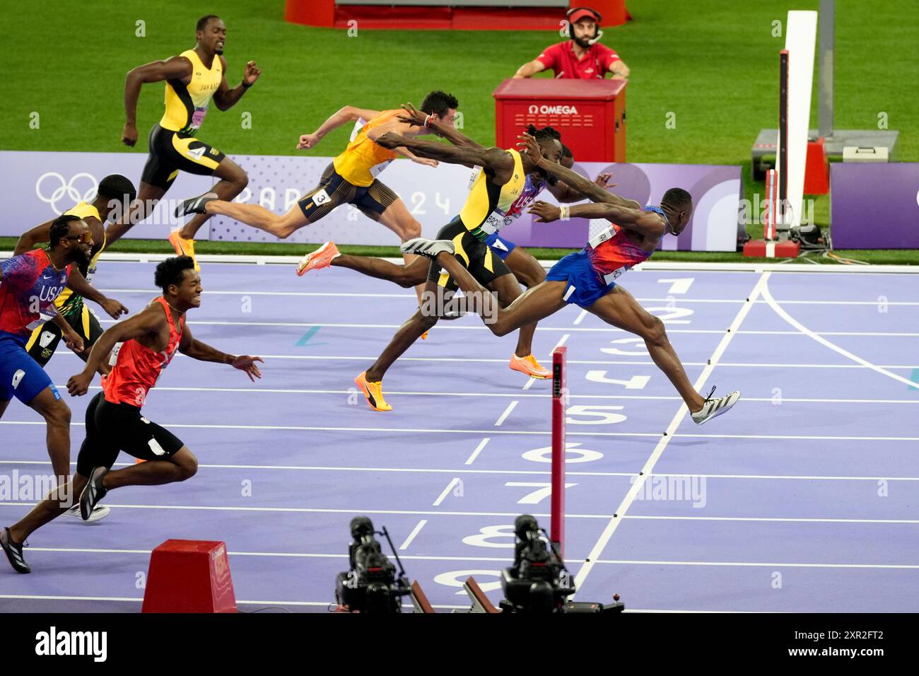 Grant Holloway, of the United States, crosses the finish line in the ...