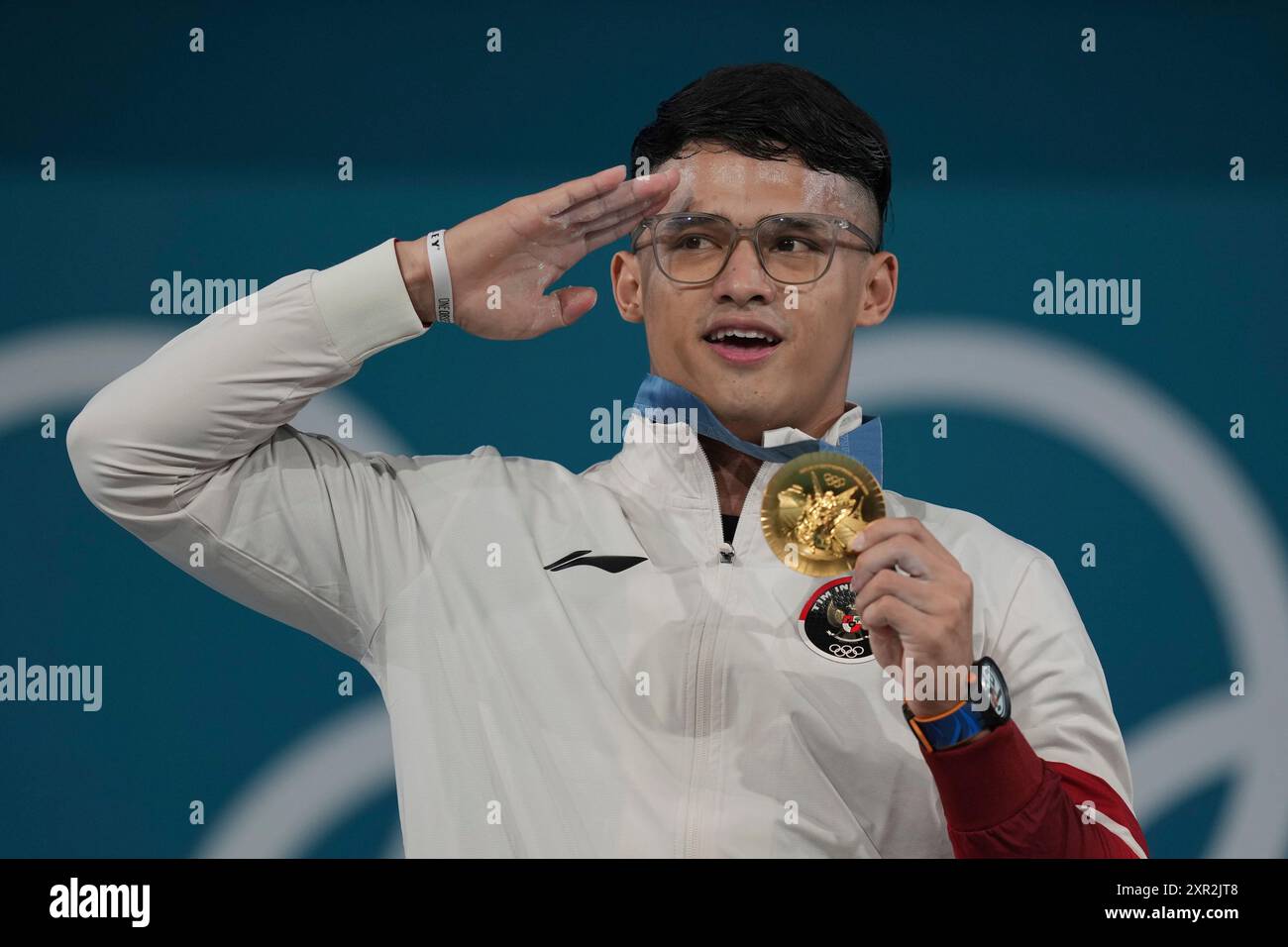 Gold medalist Rizki Juniansyah of Indonesia celebrates on the podium ...