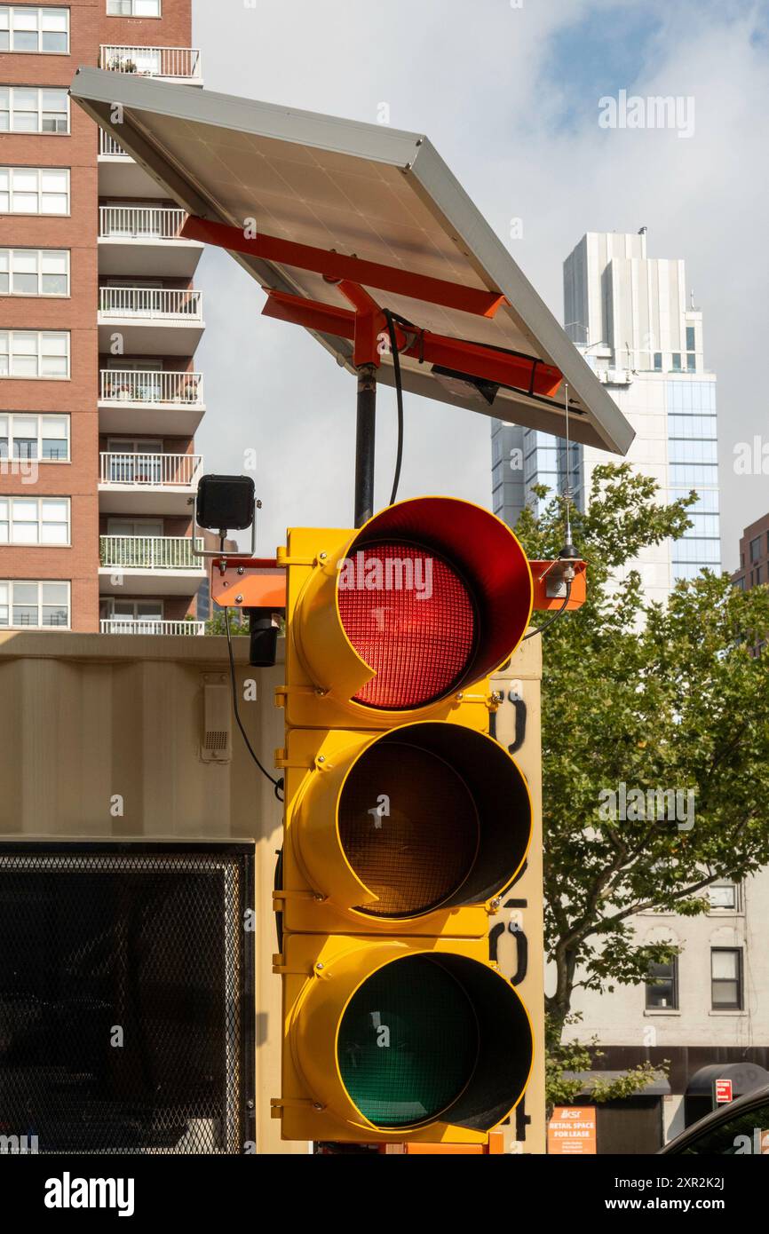 Close-up of a traffic light powered by a small solar panel, 2024, New ...