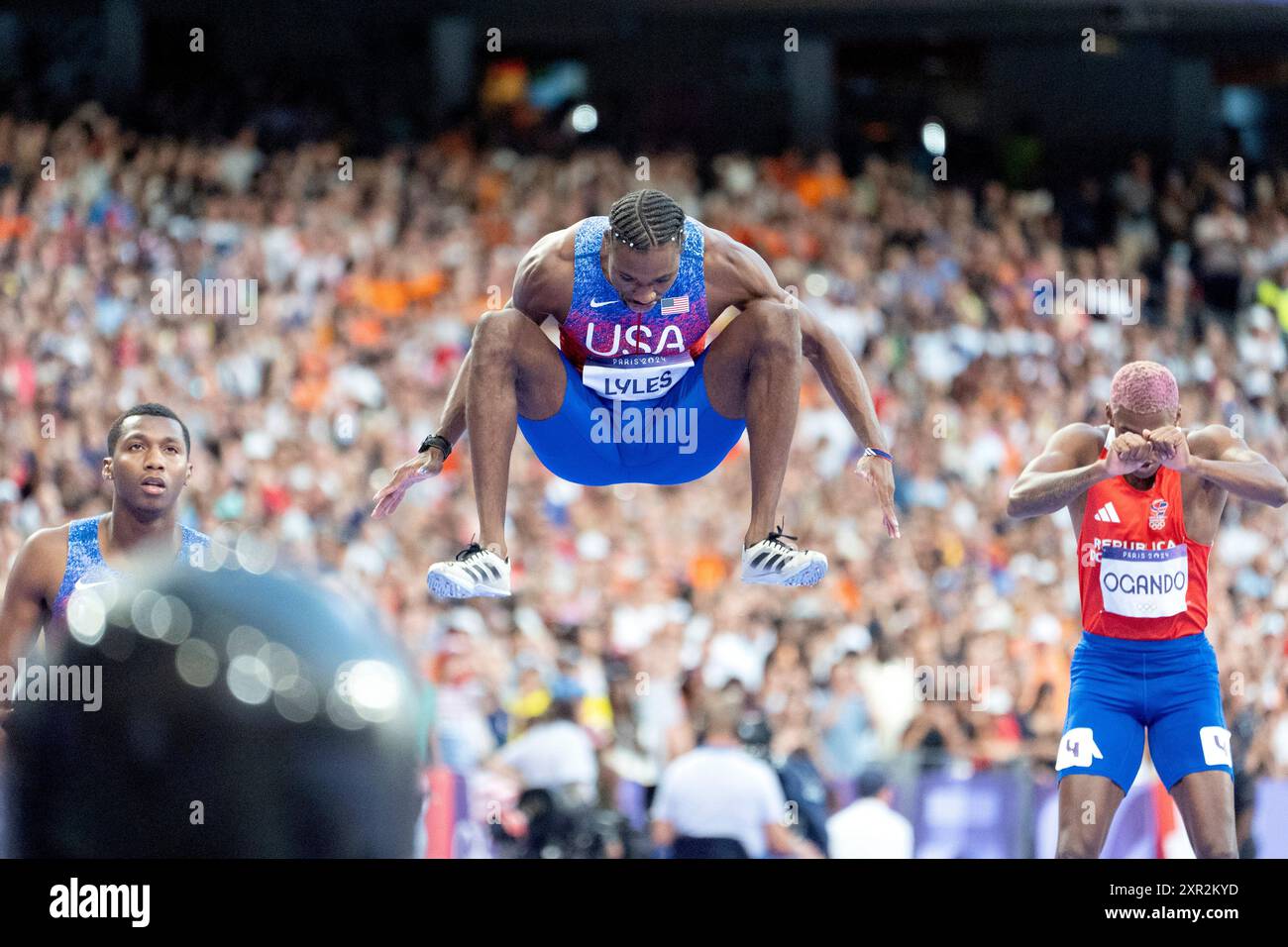 Noah Lyles, of the United States, jumps in the air before the start of ...