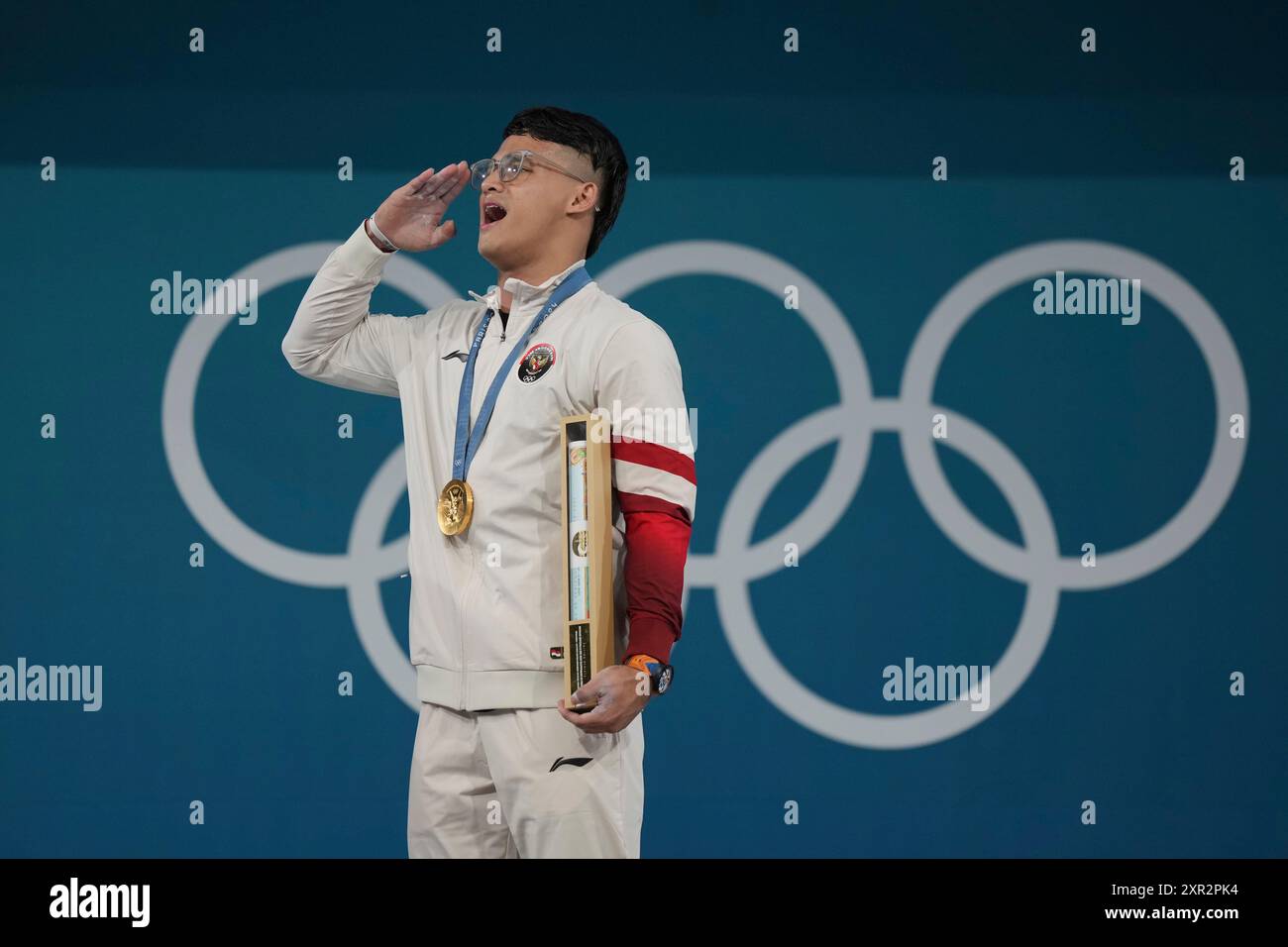 Gold medalist Rizki Juniansyah of Indonesia celebrates on the podium ...