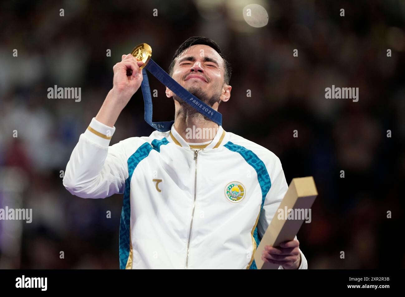 Uzbekistan's Ulugbek Rashitov celebrates on the podium after winning ...