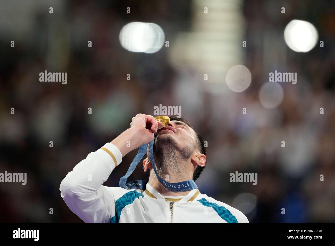 Uzbekistan's Ulugbek Rashitov celebrates on the podium after winning ...