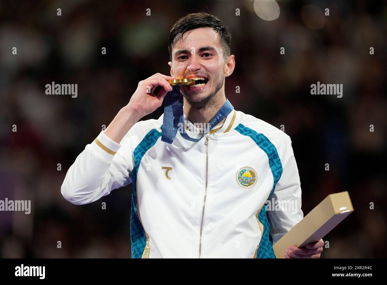 Uzbekistan's Ulugbek Rashitov celebrates on the podium after winning ...