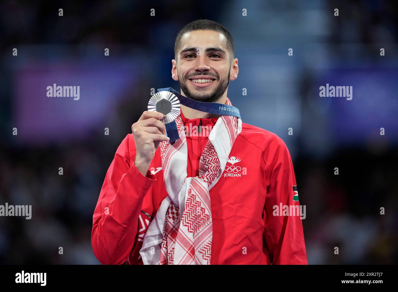 Jordan's Zaid Kareem celebrates on the podium after winning the silver ...