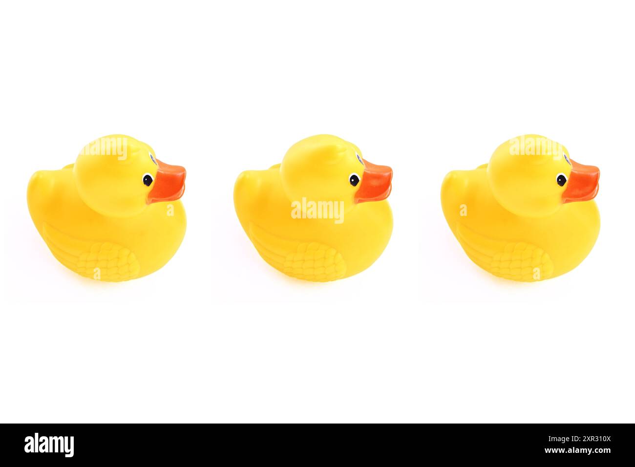 Three yellow rubber ducks in a line on white background Stock Photo - Alamy