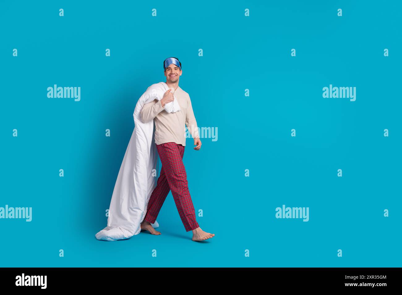 Full body photo of attractive young man hold blanket walking dressed ...