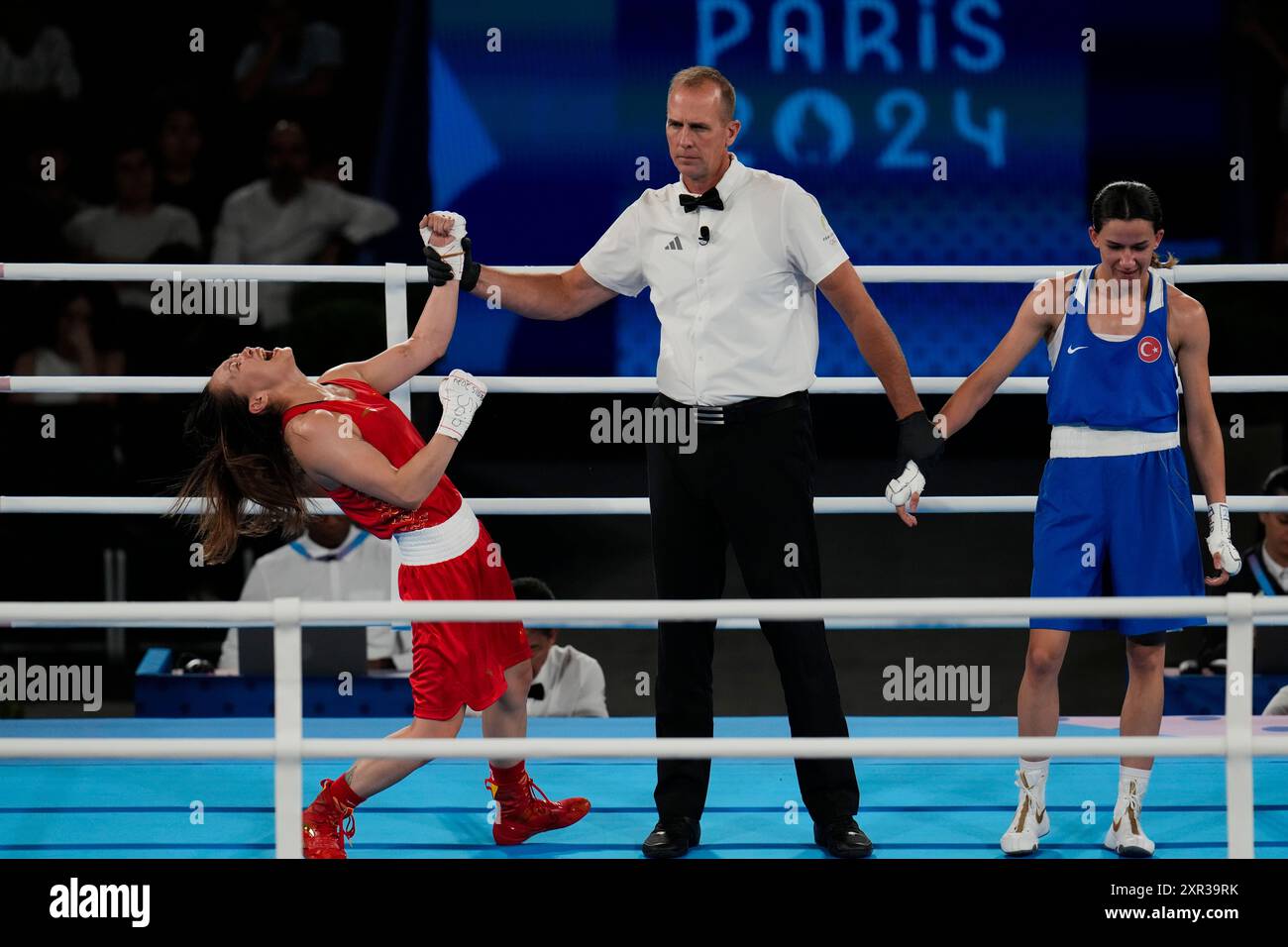 China's Chang Yuan, left, celebrates after defeating Turkey's Hatice ...