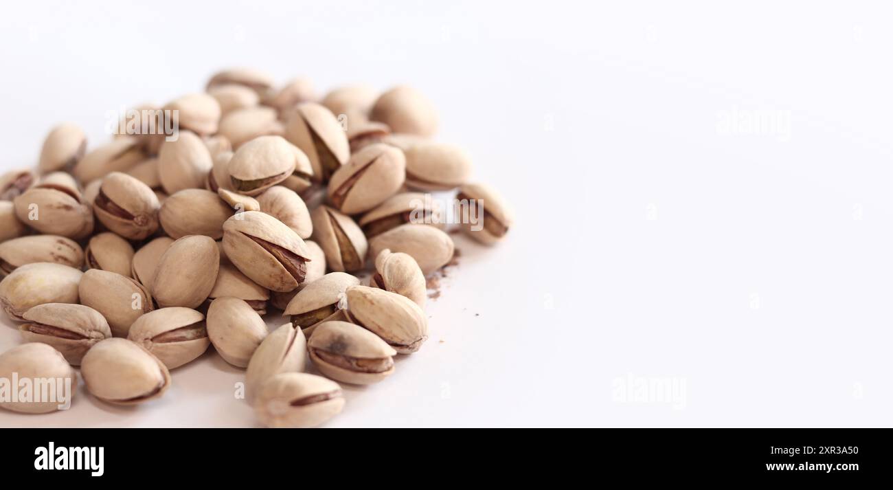 Pistachios on a white background. A handful of dry salted pistachios on a light background ...