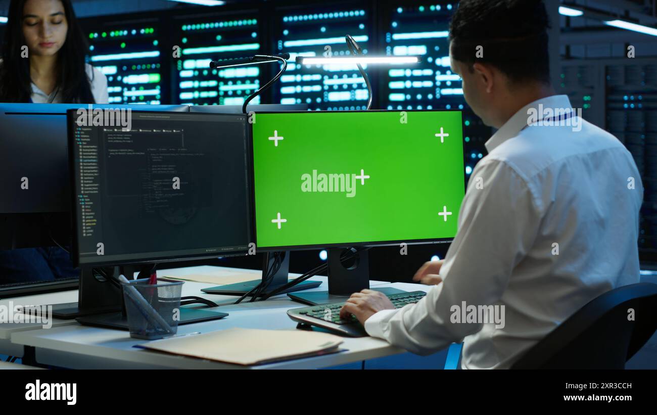 Technician using mockup computer in data center, managing servers, operating systems. Expert in ...