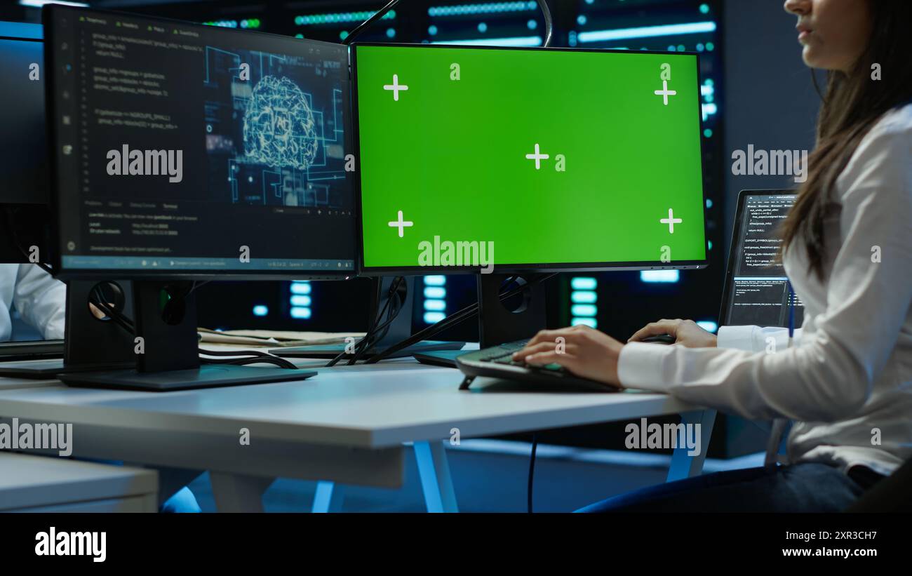 Admin using AI tech on isolated screen PC to do maintenance in server room. Specialist in data ...