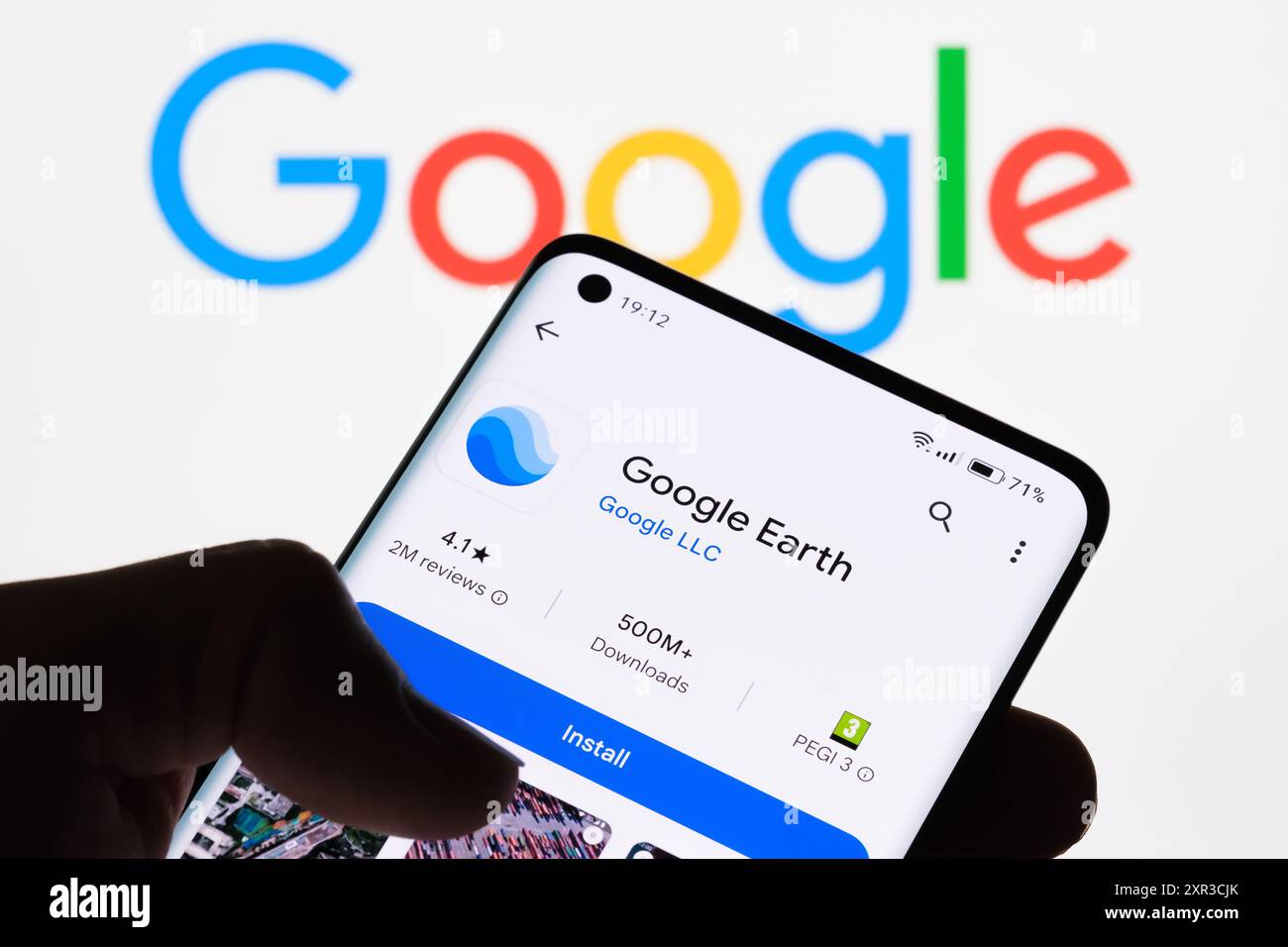 Close-up of a smartphone screen displaying Google Earth app with Google logo in the background ...