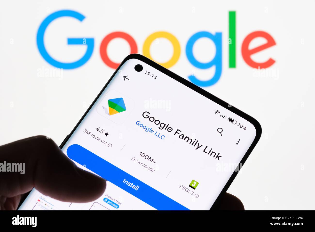 Close-up of a smartphone screen displaying Google Family Link app with Google logo in the ...