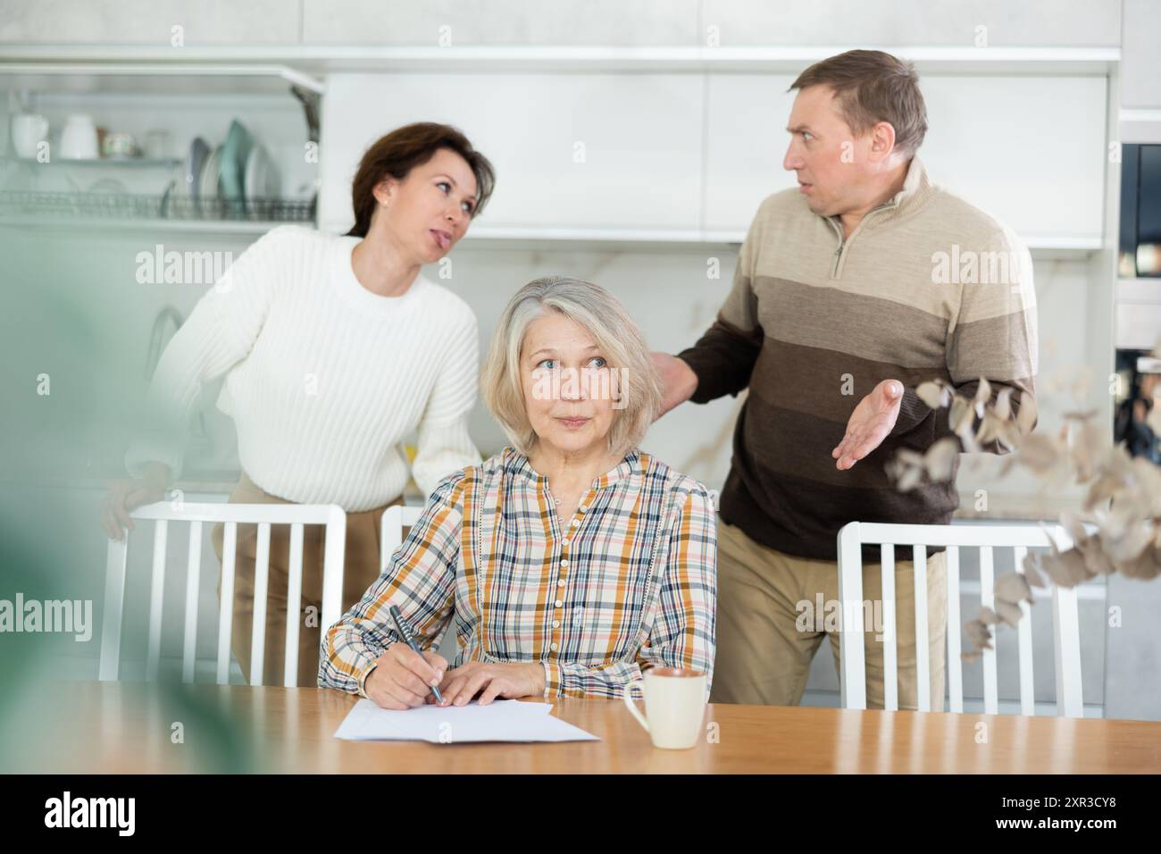 Old woman signing papers Stock Photo - Alamy