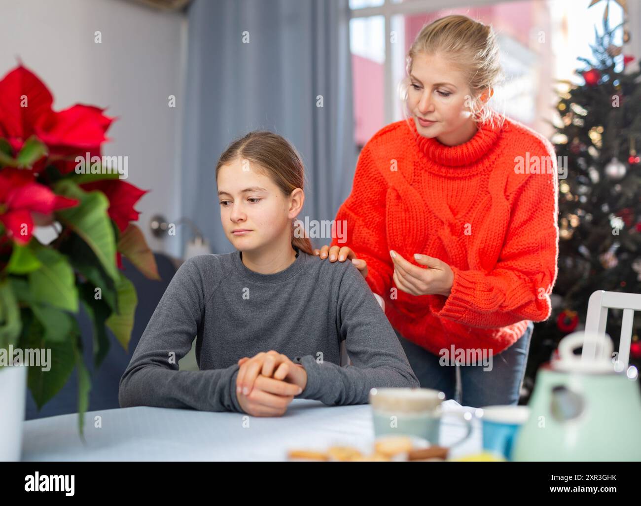Mom soothes her teen daughter after a fight during Christmas holidays ...