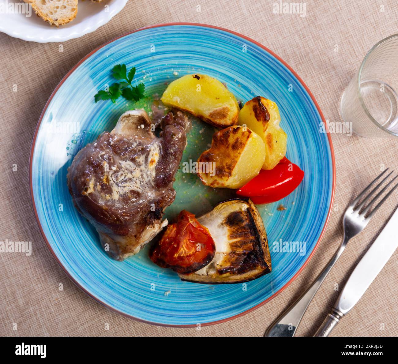 Baked pork cheek served with vegetables Stock Photo - Alamy