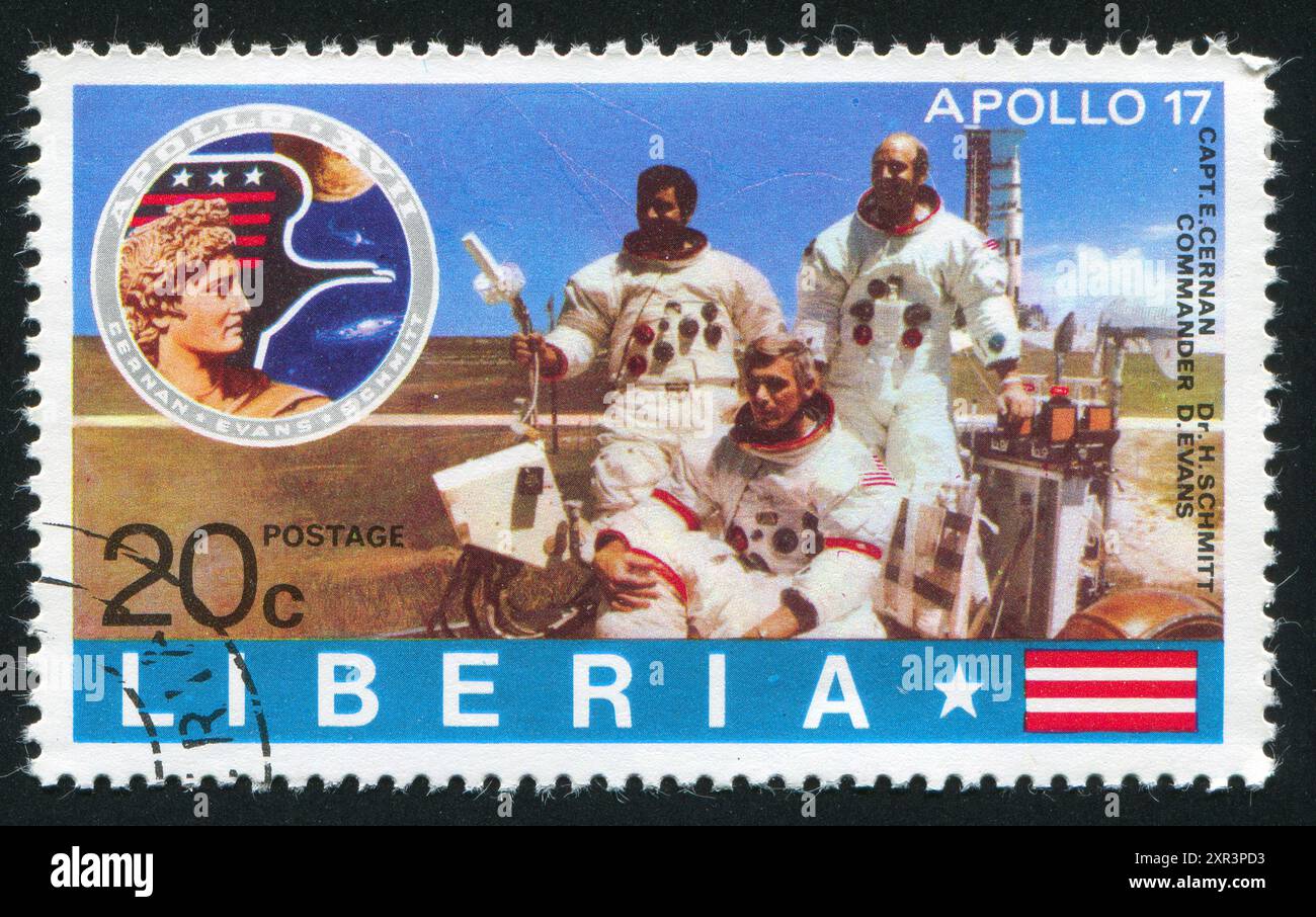 LIBERIA - CIRCA 1973: stamp printed by Liberia, shows Apollo badge and astronauts on launching ...