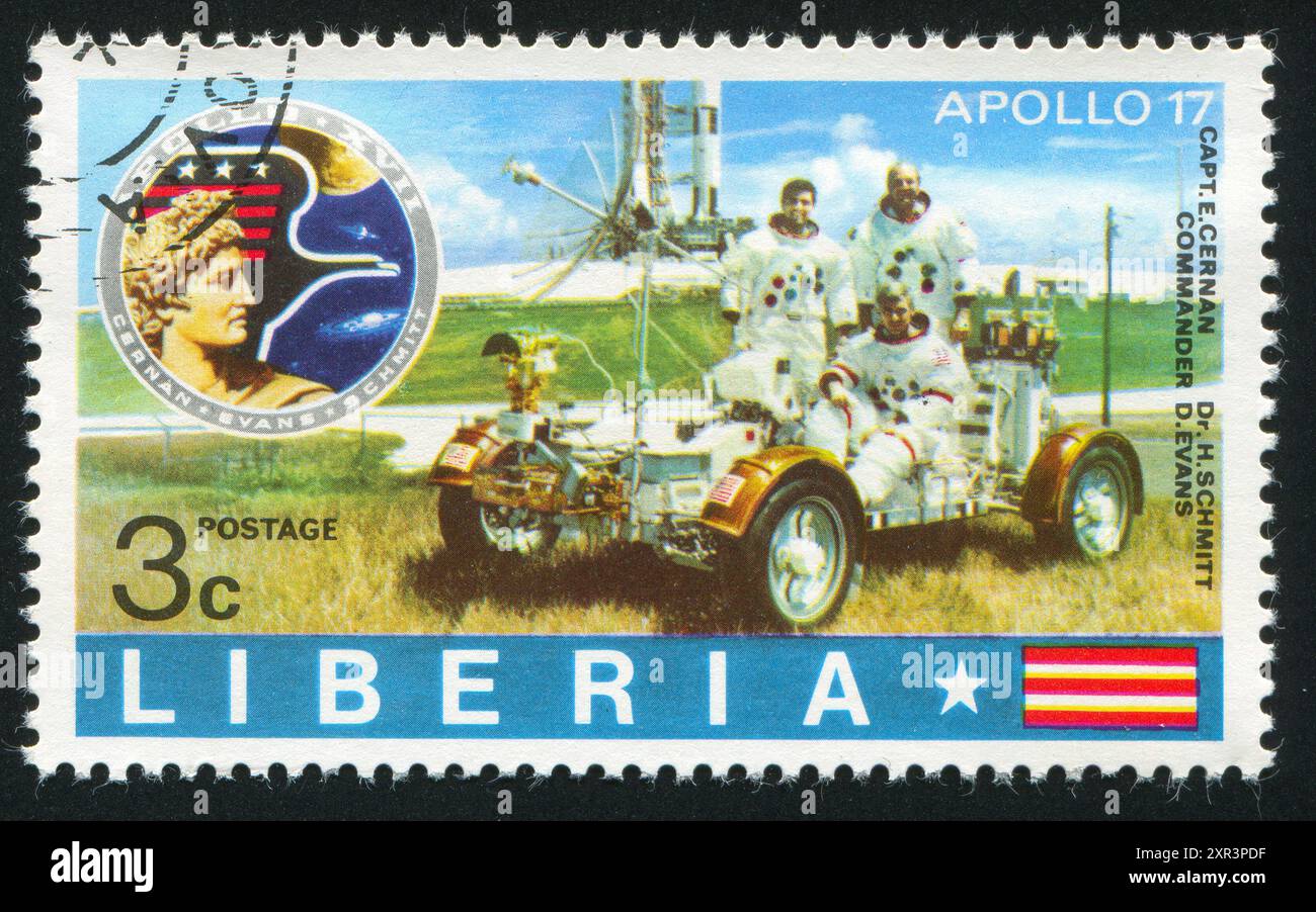 LIBERIA - CIRCA 1973: stamp printed by Liberia, shows Apollo badge and astronauts on earth in ...