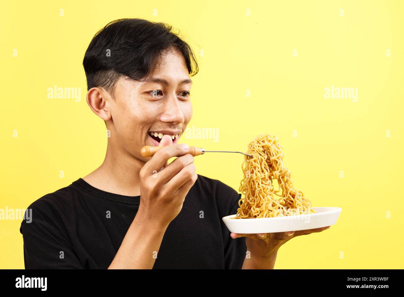 Indonesian Young Man Eating Indomie Fried Noodle, Happy Face Stock ...