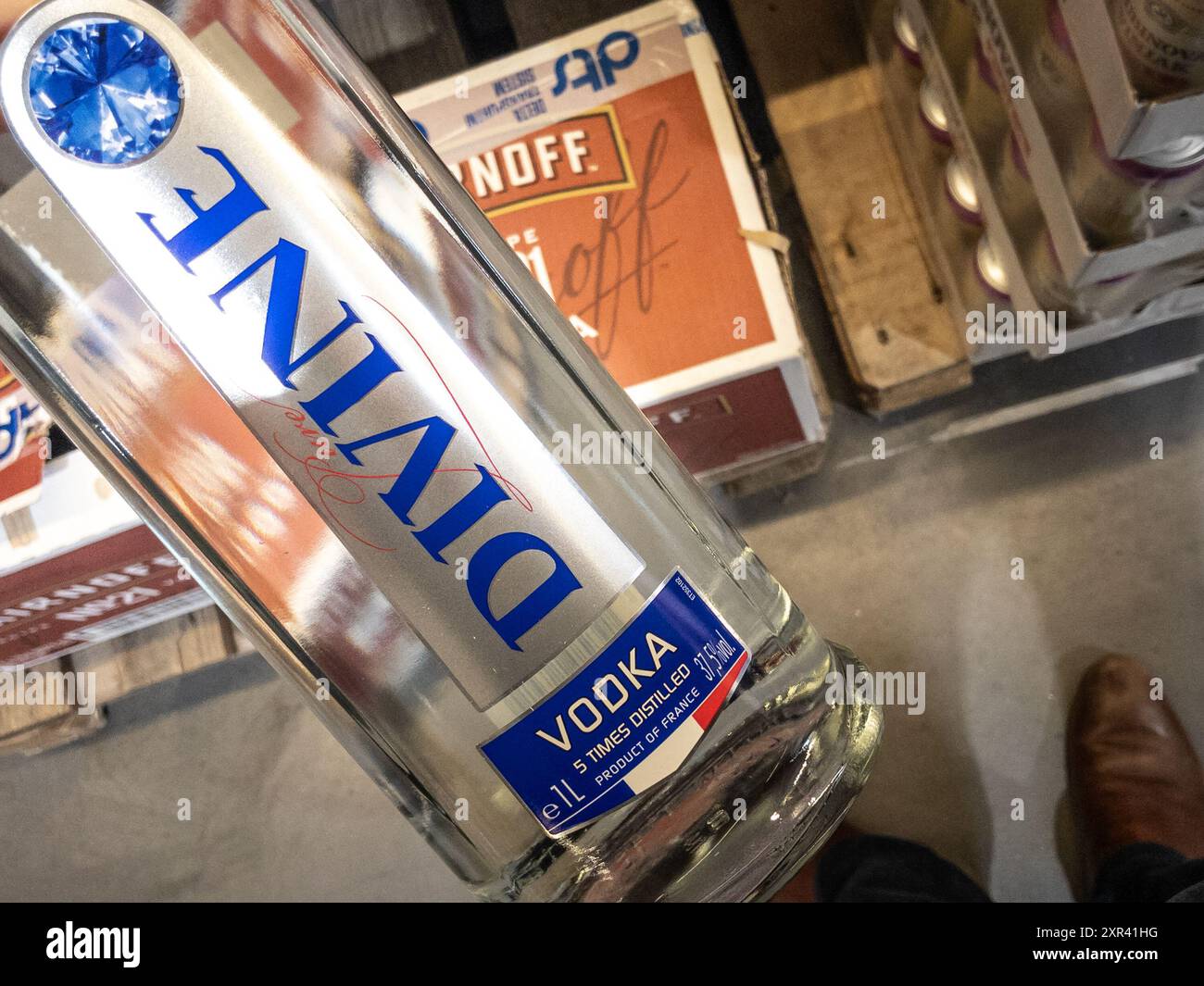 This image depicts a bottle of Divine Vodka on display in a Belgrade ...
