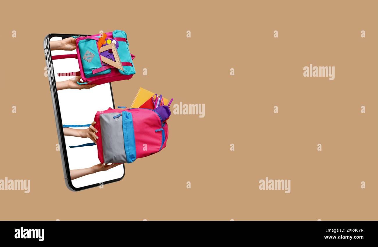 Big mobile phone with hands holding school backpacks on brown ...