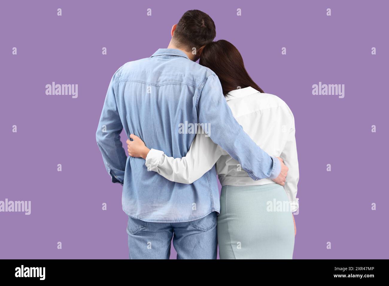Young couple hugging on lilac background, back view Stock Photo - Alamy
