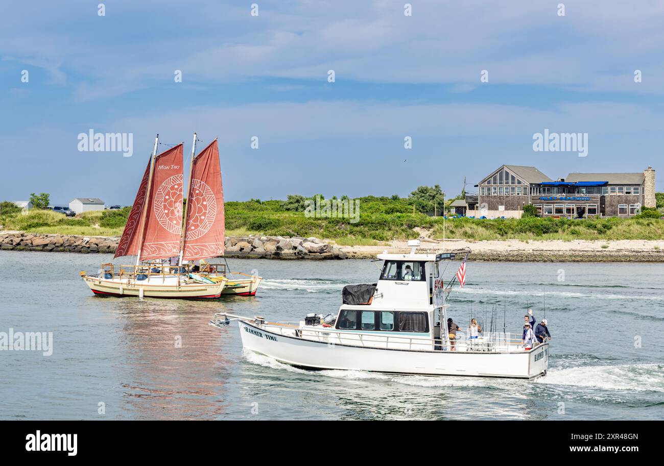 a fishing boat and a sail boat leaving montauk harbor Stock Photo - Alamy