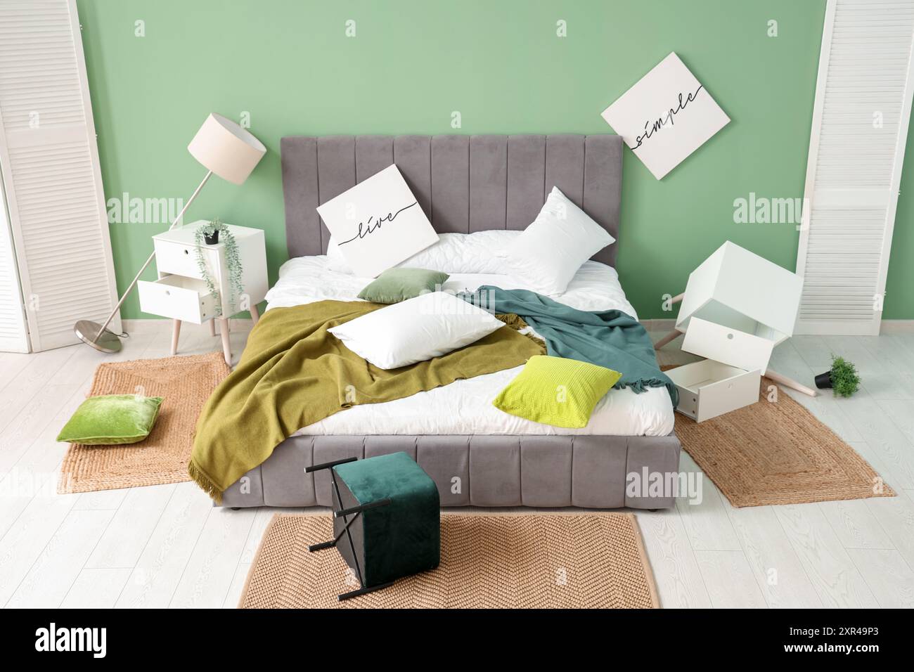 Interior of messy bedroom with posters and overturned pouf Stock Photo ...