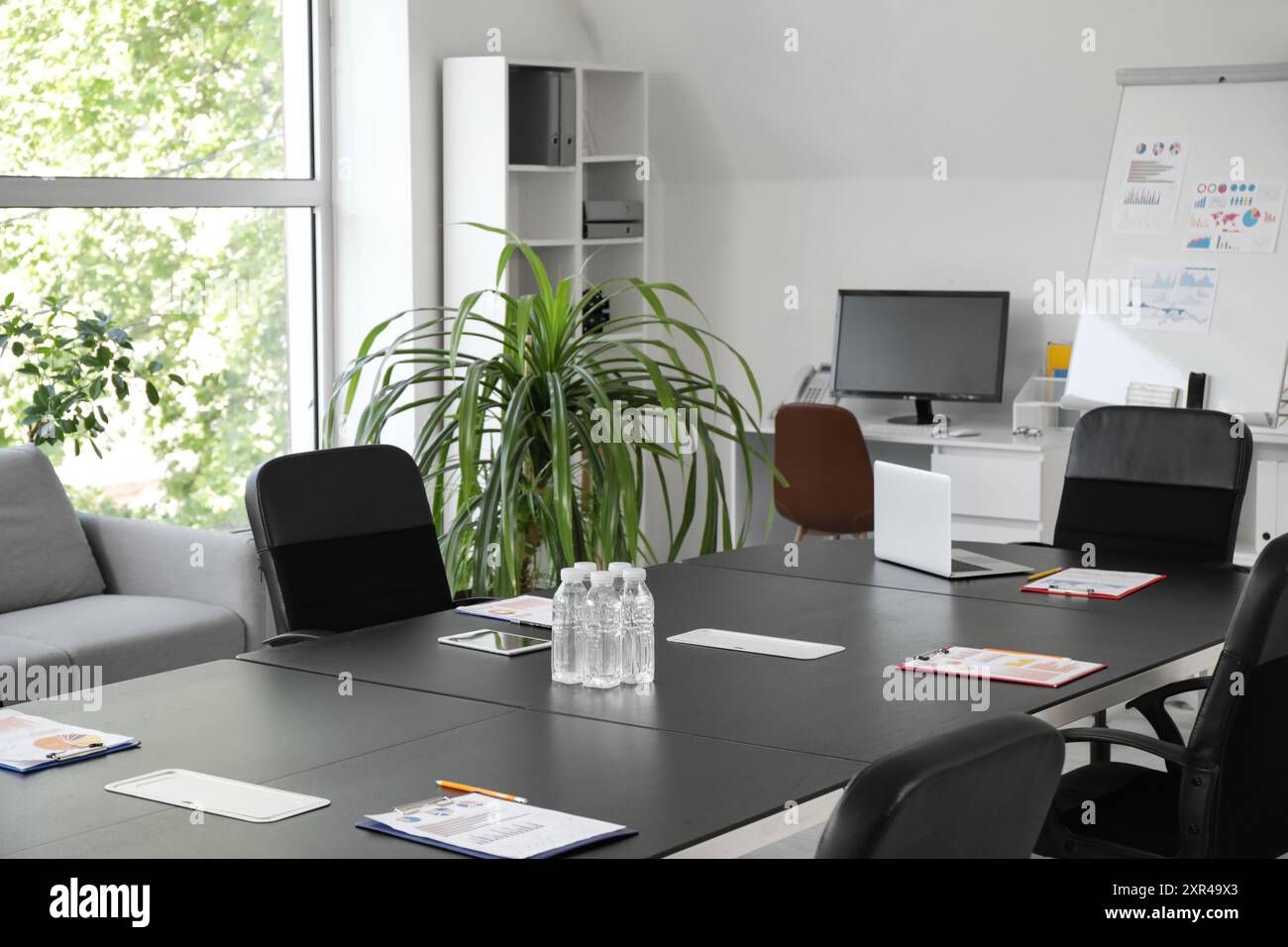 Interior of modern conference hall with big table, armchairs, shelving ...