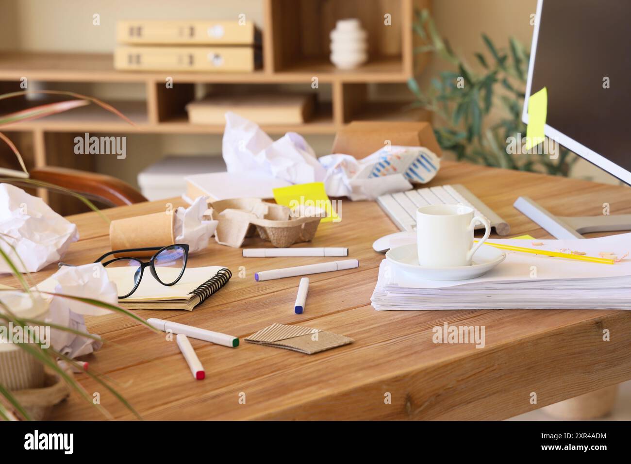 Messy workplace with crumpled paper and garbage in office, closeup ...