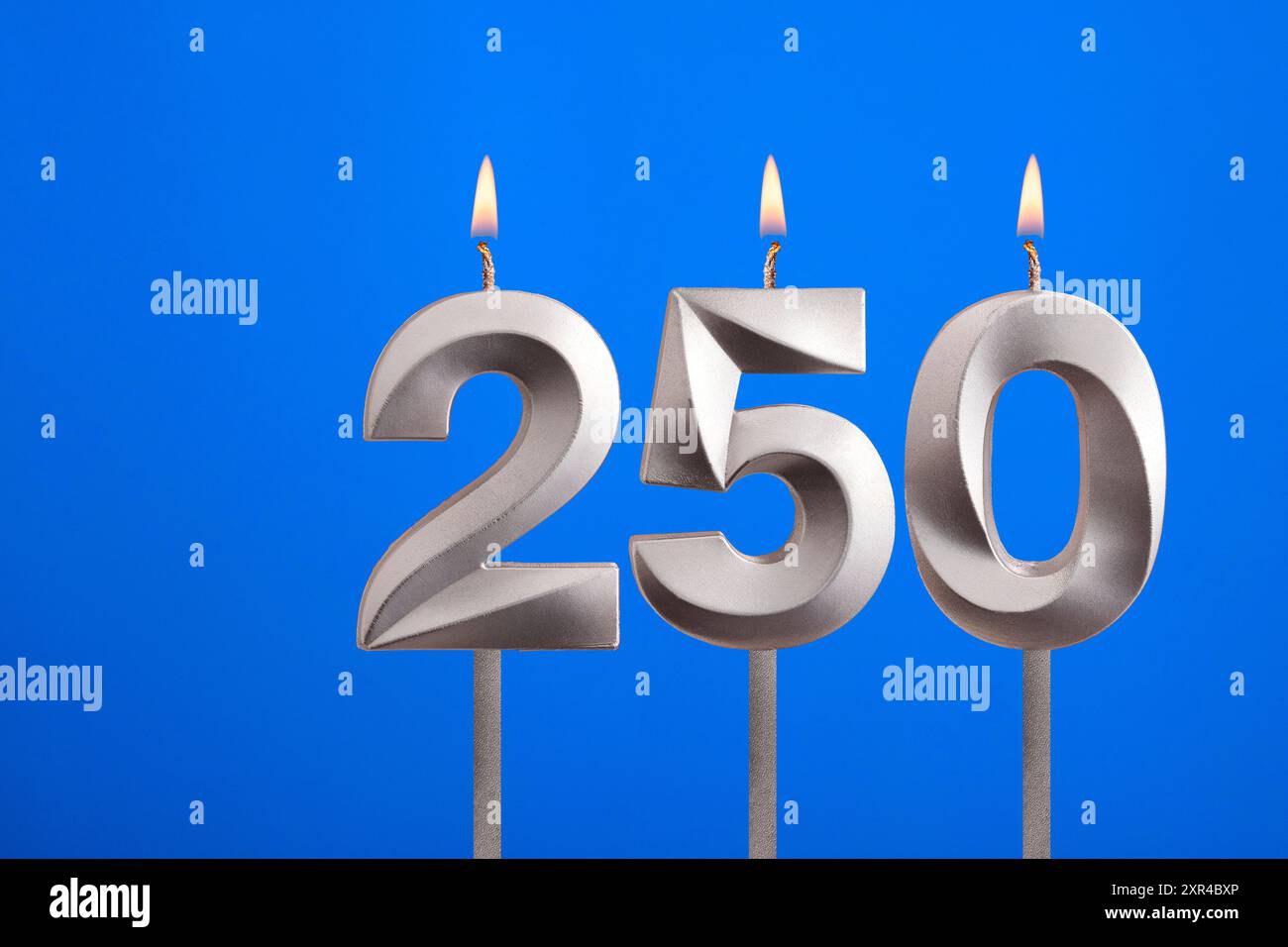 Birthday number 250 - Candle lit on blue background Stock Photo - Alamy