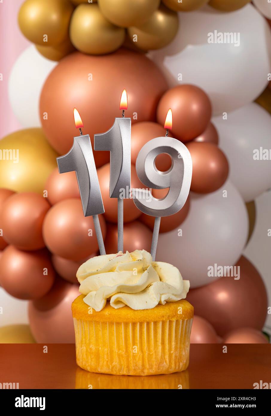 Cupcake with birthday candle on balloons background - Number 119 Stock ...