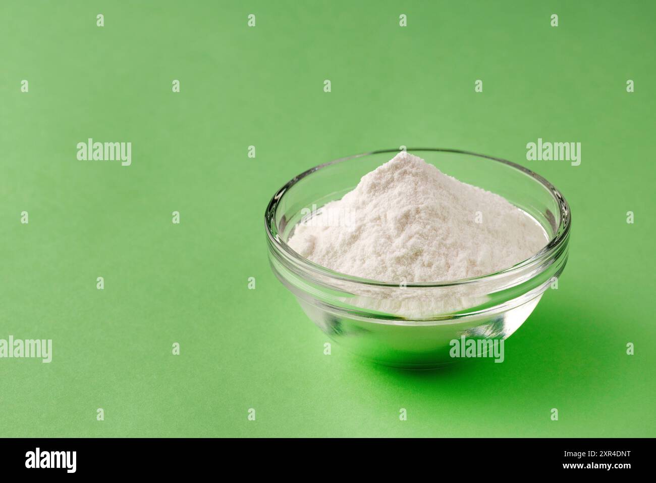 Baking soda - Crystalline solid compound in the bowl. Green background ...