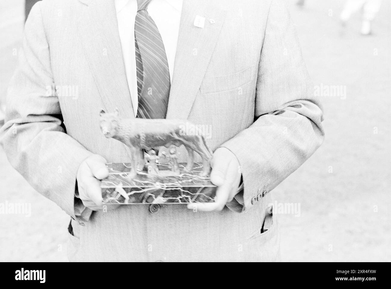 Man with statue of the founders of Rome: Romulus, his twin brother ...