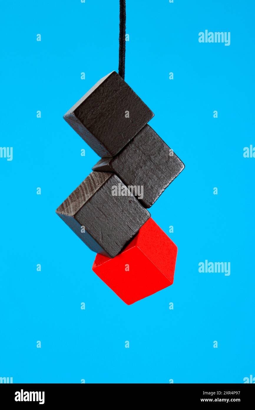 Pendulum holding several wooden cubes on its axis Stock Photo - Alamy