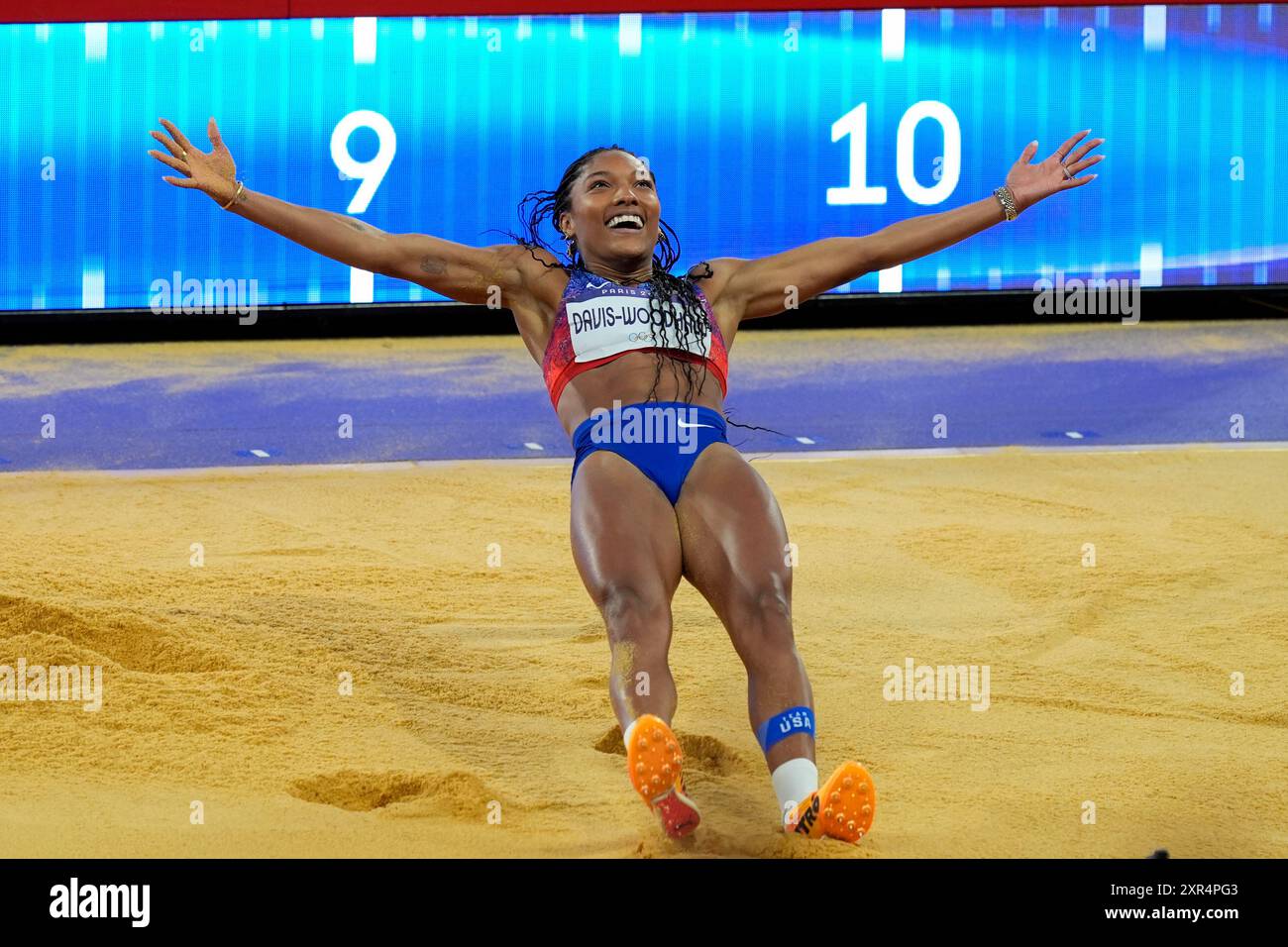 Tara Davis-Woodhall, of the United States, falls back into the sand pit ...