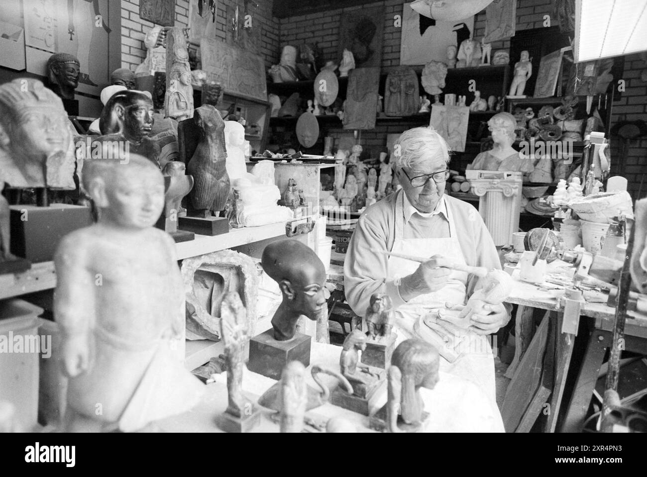 Gé Loogman paints statues in a studio, Zandvoort, 19-08-1992, Whizgle ...