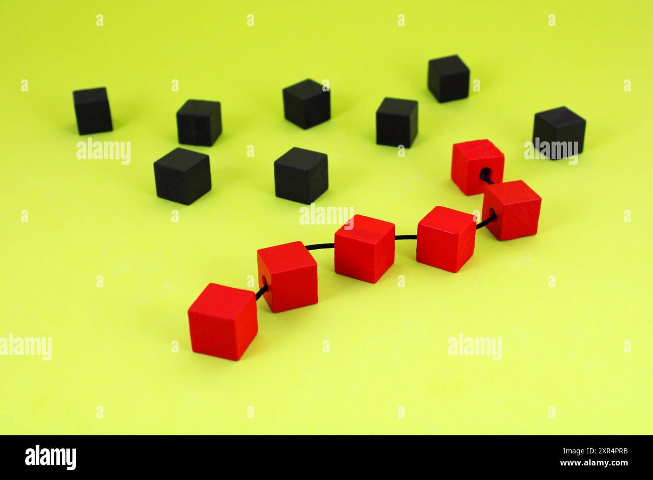 Wooden cubes of different colors that are separated into two groups ...