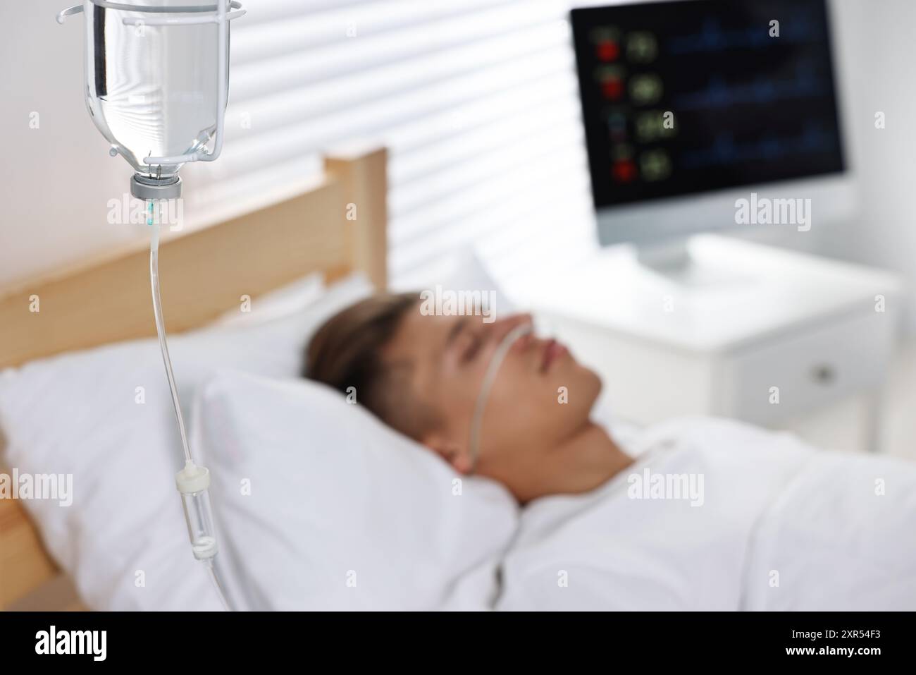 Coma patient. Young man sleeping in hospital bed, selective focus Stock ...