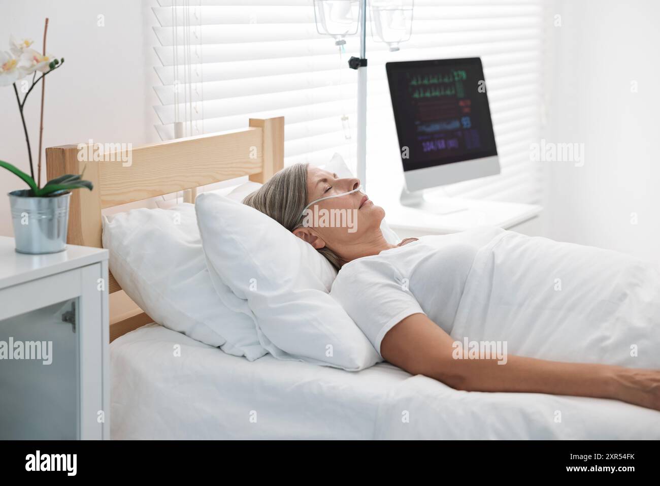 Coma patient. Mature woman sleeping in hospital bed Stock Photo - Alamy