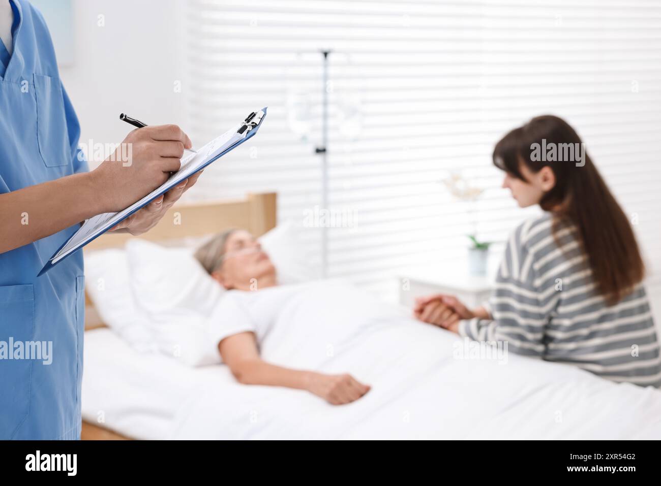 Coma patient. Doctor near unconscious mature woman in hospital, closeup ...