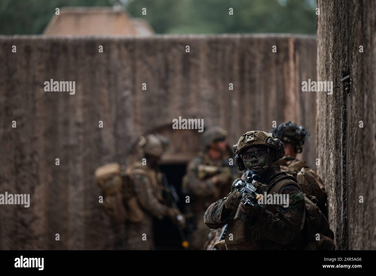 U.S. Marines stack on a wall while entering a training area during an ...