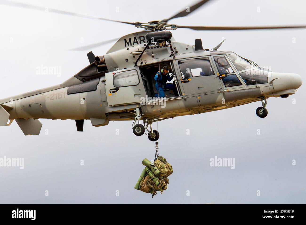 A Mexican aircrewman lowers supplies from a Mexican AS565 Panther ...