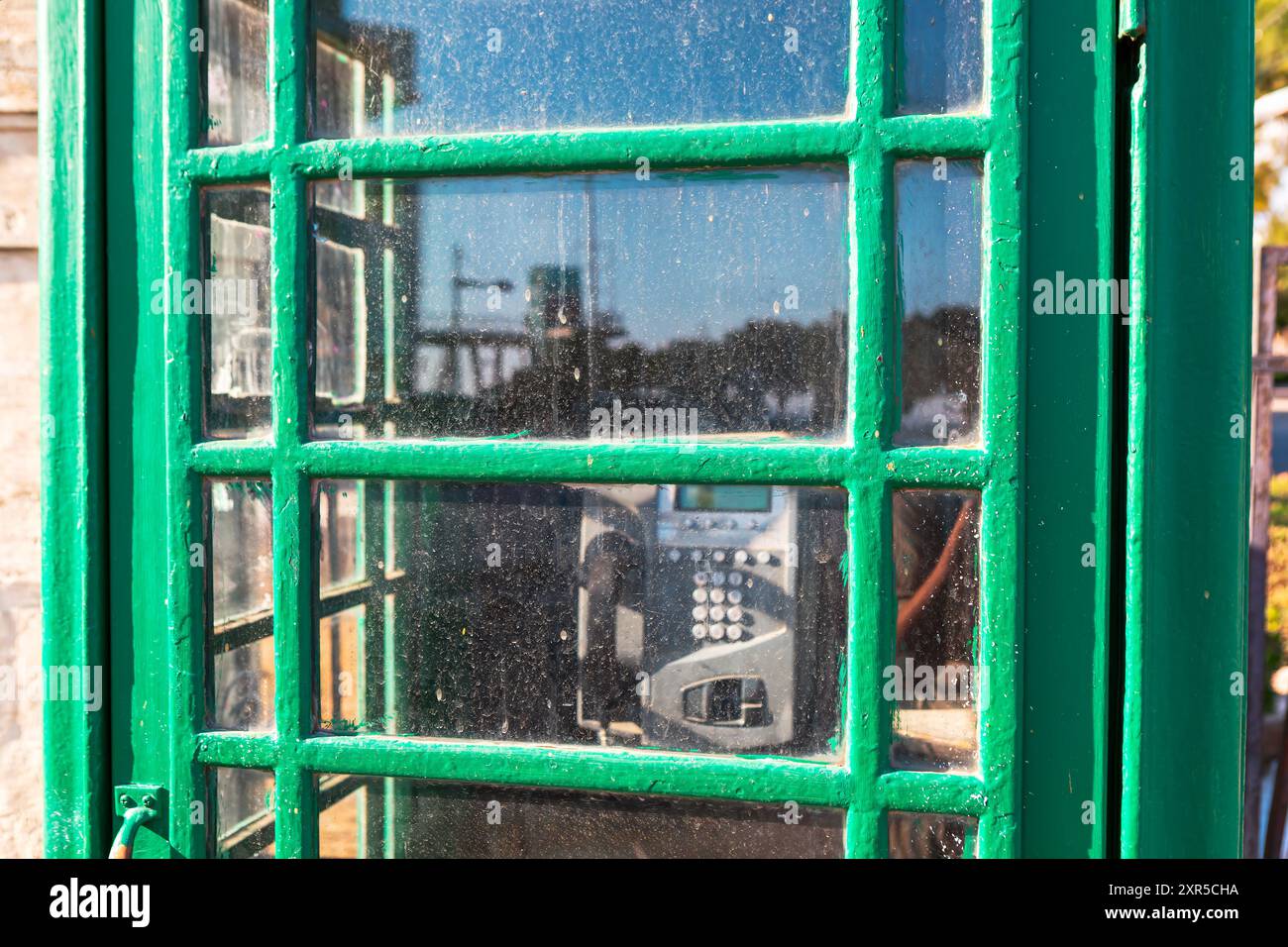 Classic green telephone booth standing on the street. Vintage green ...