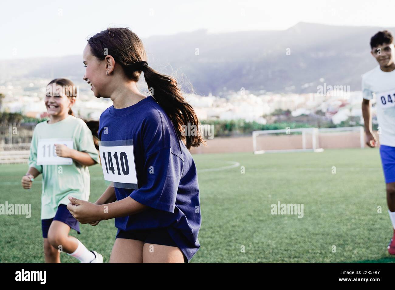 Sport children running in marathon competition at school soccer field ...