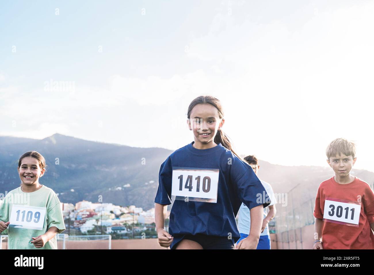 Sport children running in marathon competition at school soccer field ...
