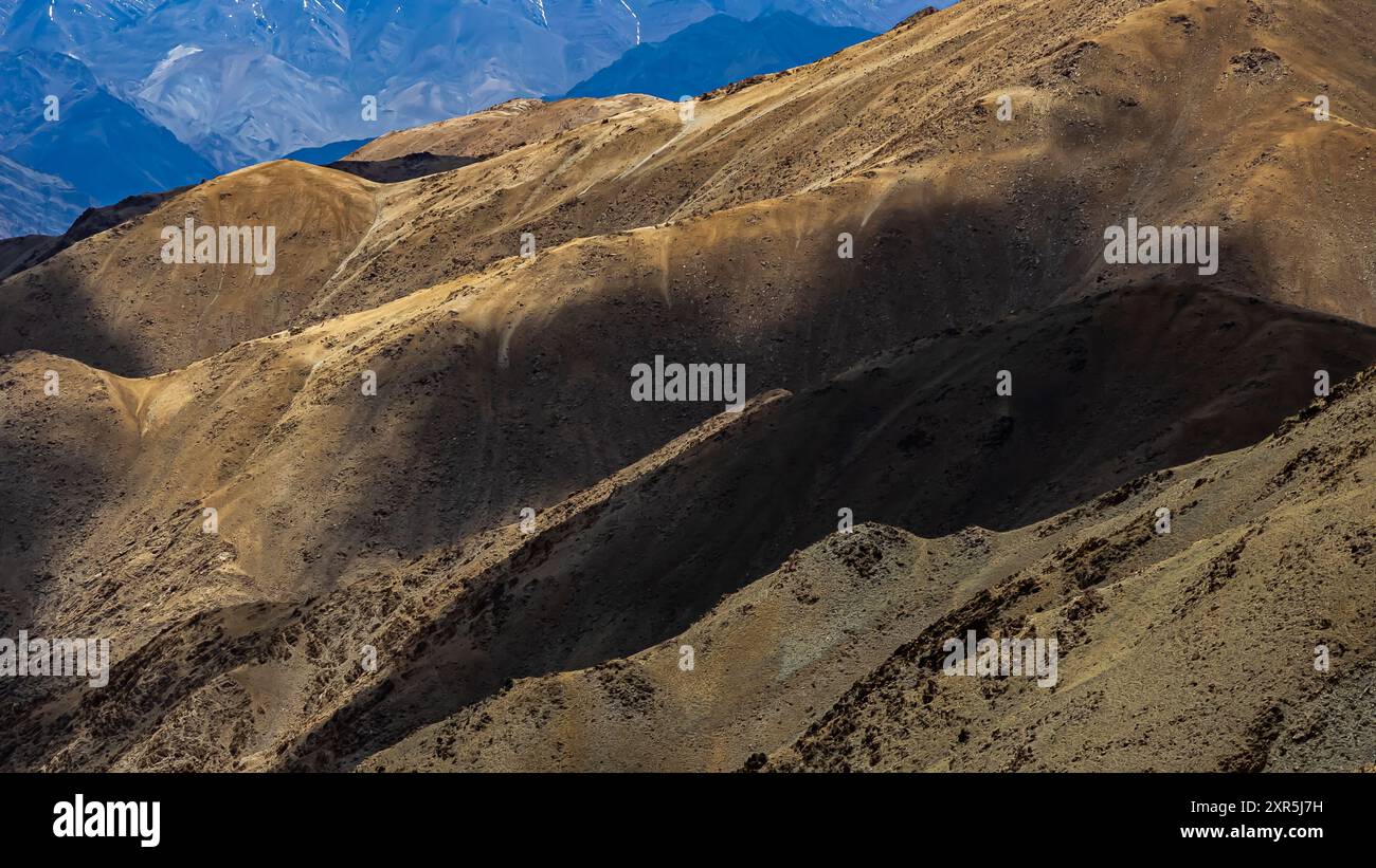 A panoramic landscape of light and shadows falling on mountains as fine ...
