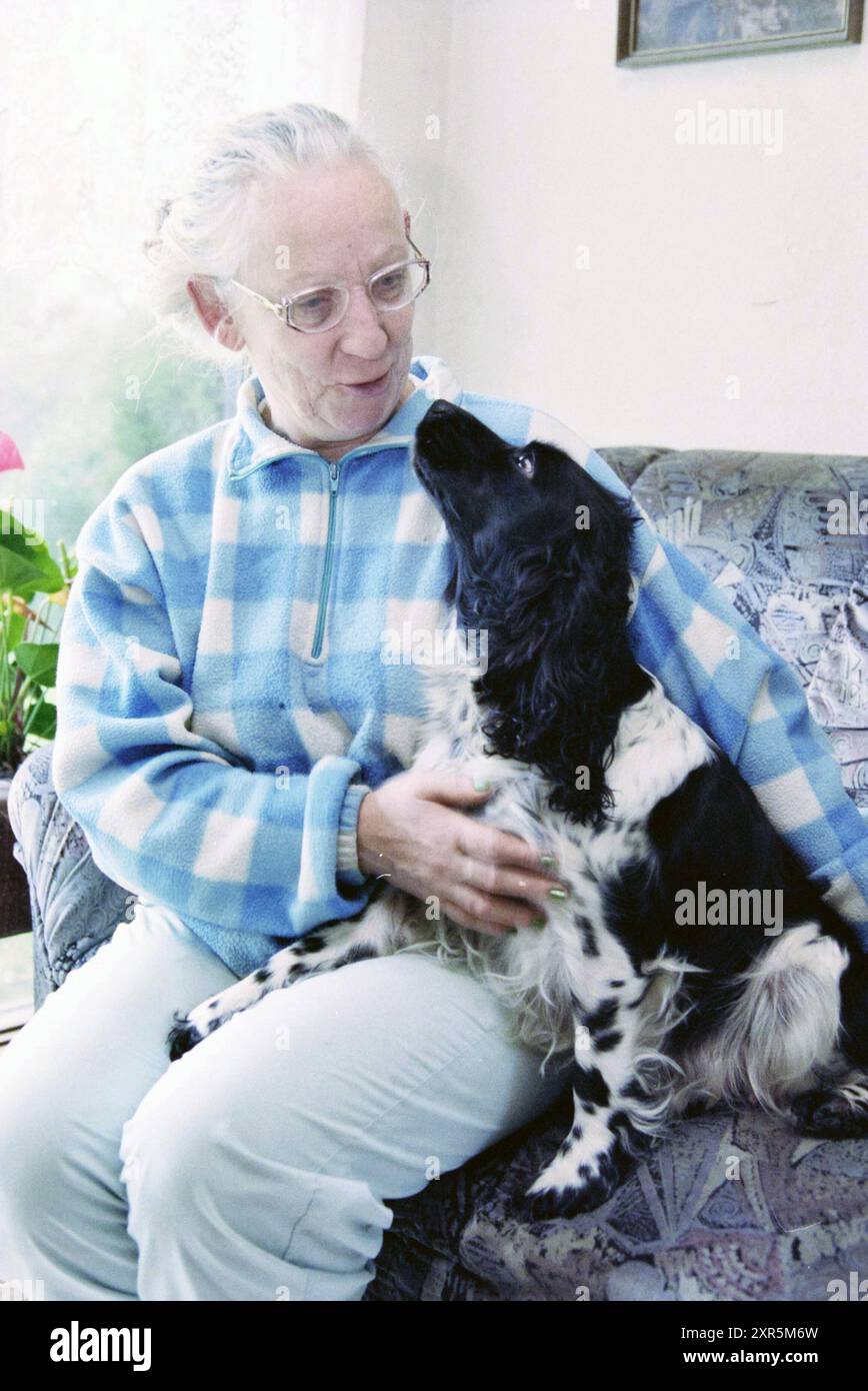Older lady on a couch with black and white spotted cocker spaniel, 00 ...