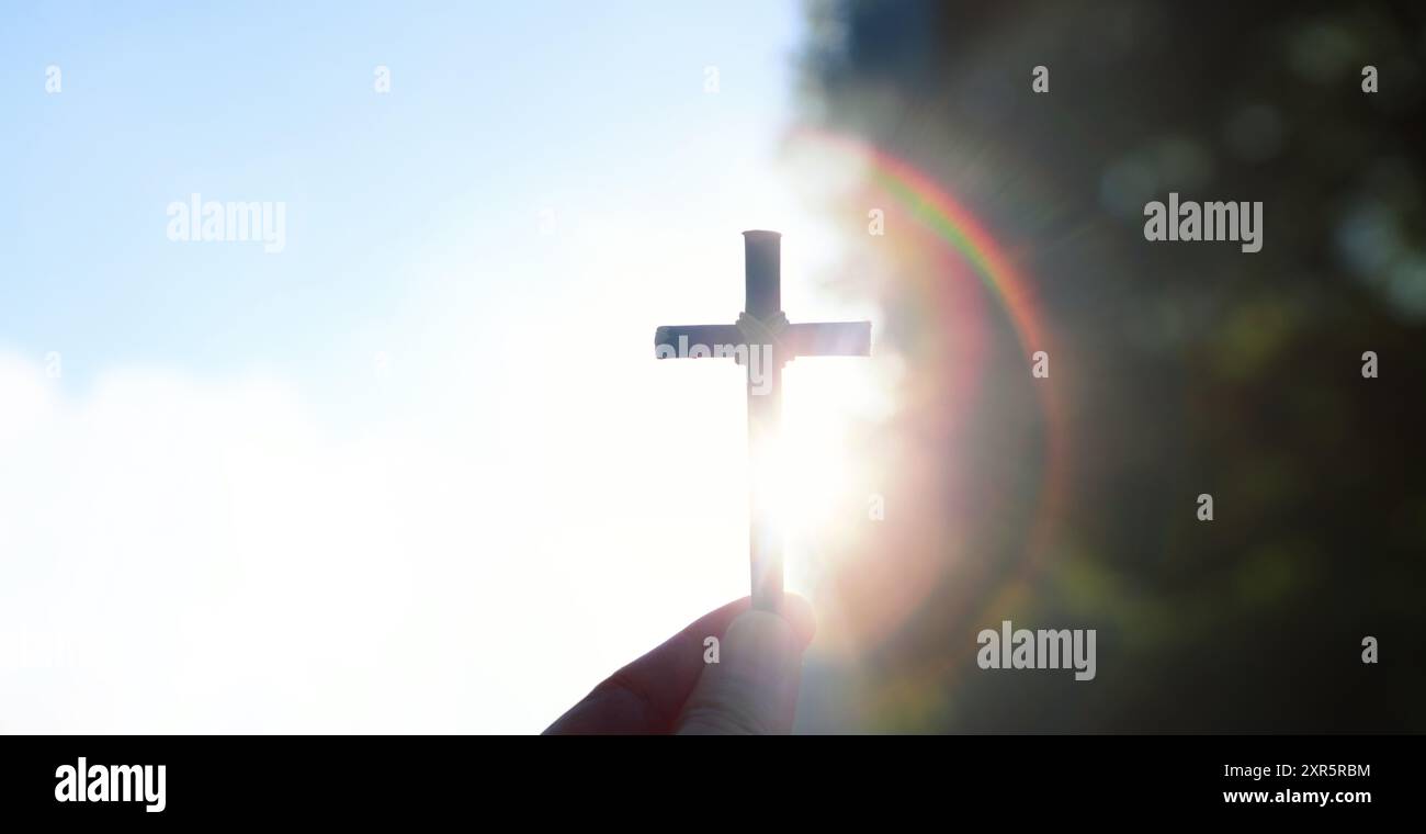 Brightly shining sun and silhouette of holy cross of Jesus Christ ...