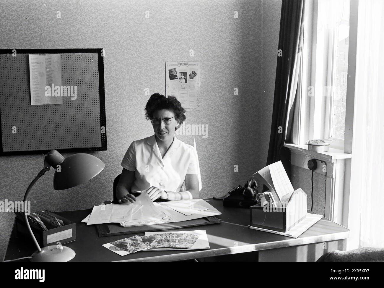 Woman, possibly headmaster, behind her desk, Whizgle Dutch News ...